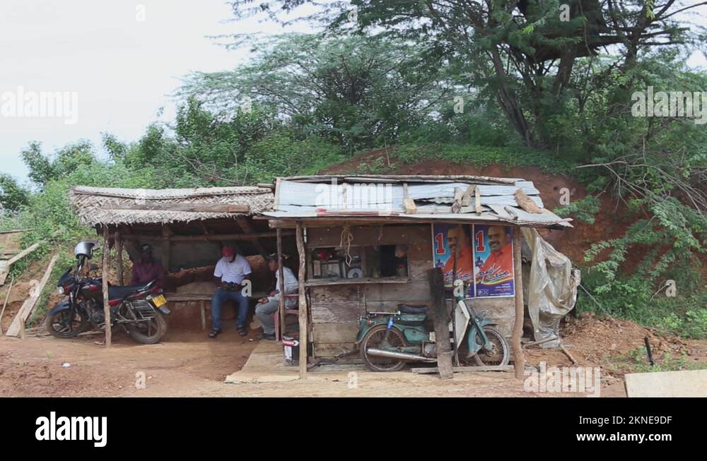 View of Asian people having a cup of tea at poor tea stall by the side ...