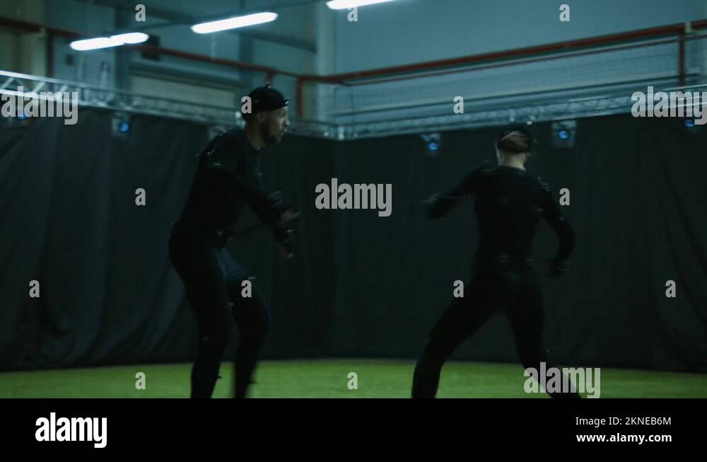 Actors in motion capture suits performing some fight moves as a game ...