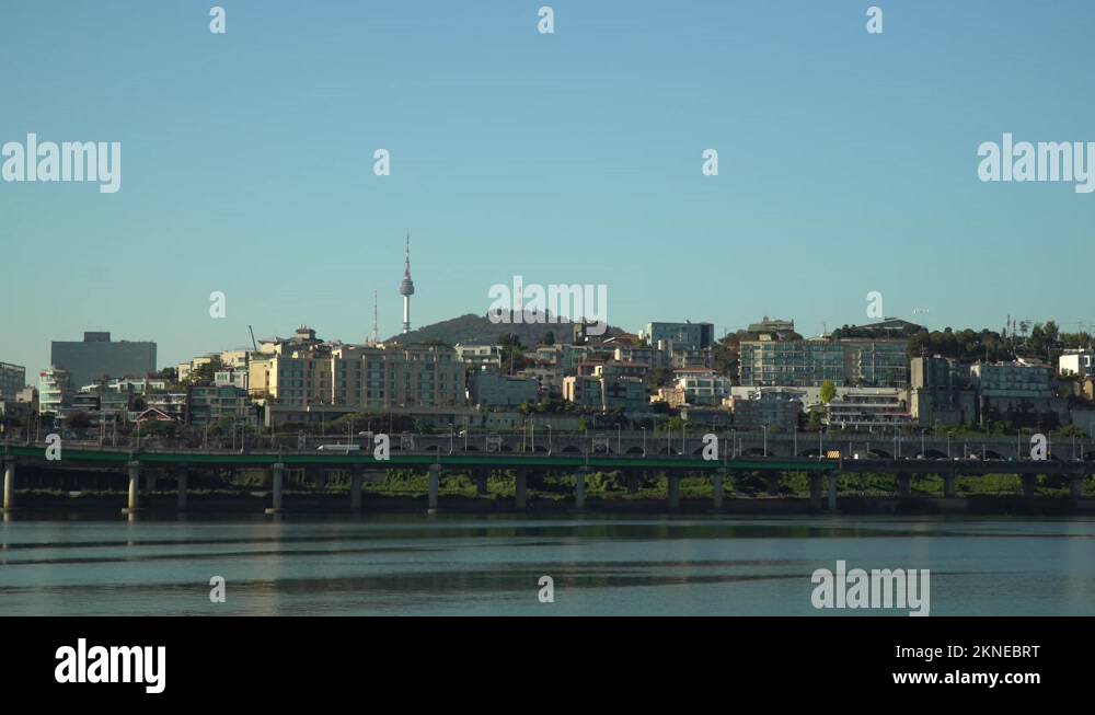 N Seoul Tower over blue cloudless sky from Han river Stock Video ...