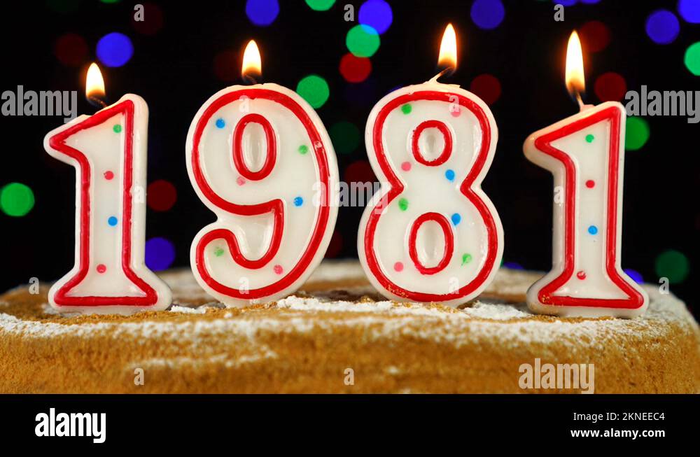 Birthday cake with white burning candles in the form of number 1981 ...