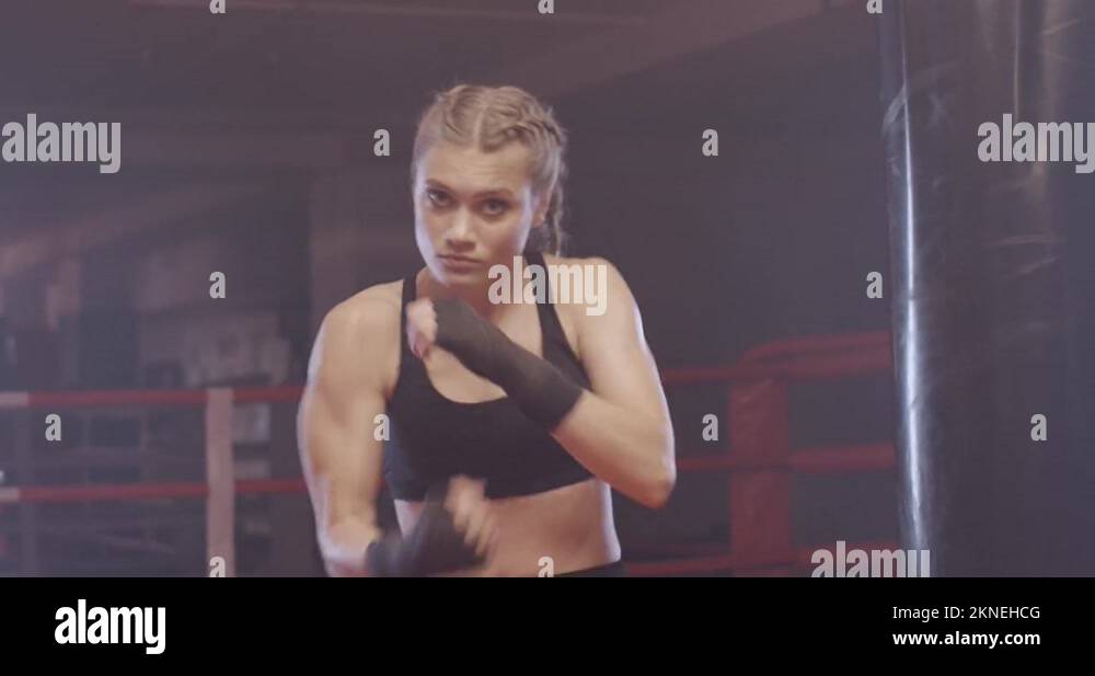 Female fighter trains his punches, training day in the boxing gym, the ...