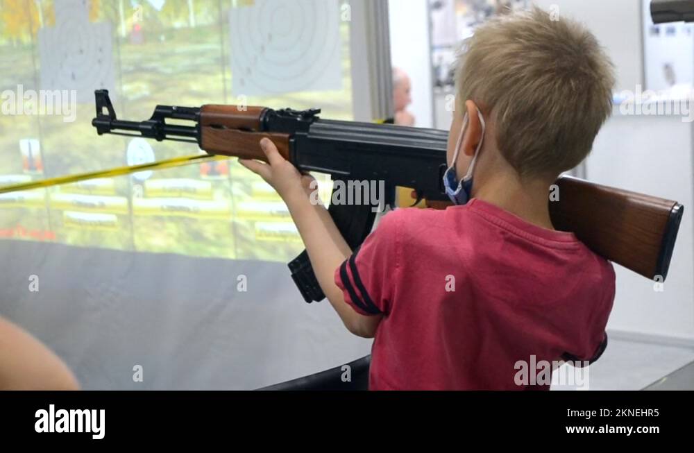 Child shoots weapon in laser dash. Airguns gun. Boy shoots weapon rifle ...