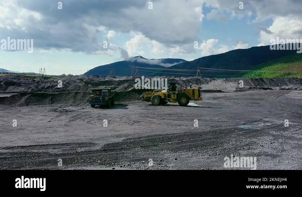 Excavator Piles Ore Mixed Into Industrial Dump Truck At Gold Mining ...
