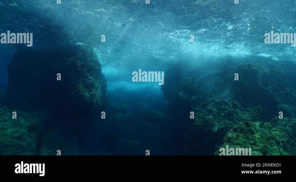 choppy water wavy sea underwater wave hit rocks and makes foam on the ...
