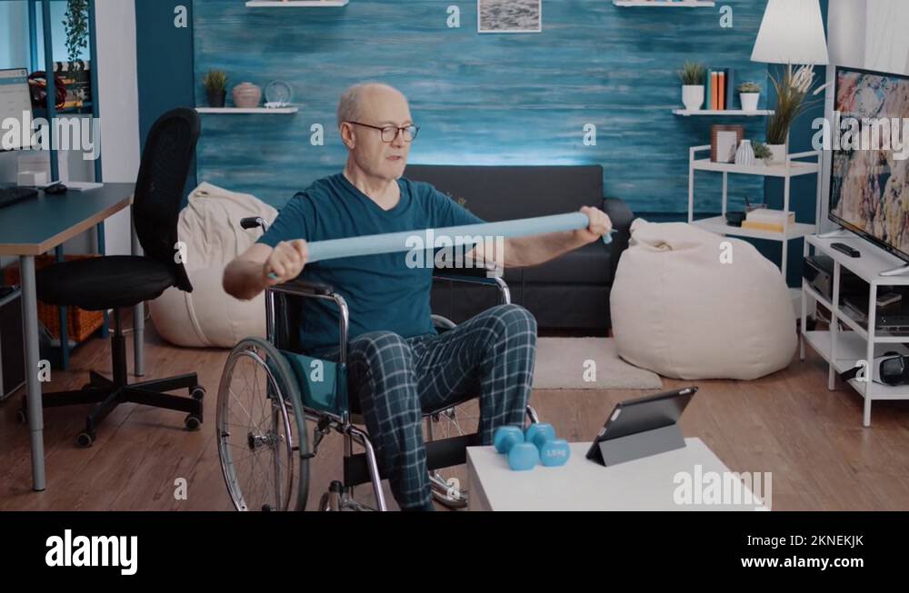 Old person with disability pulling resistance band to stretch Stock ...