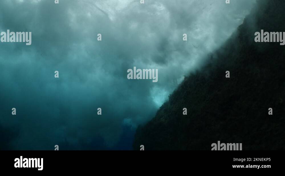 choppy water wavy sea underwater wave hit rocks and makes foam on the ...
