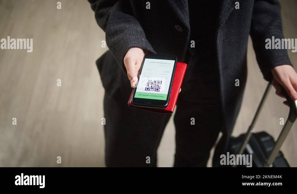 Tourist showing QR code on phone in airport terminal. Vaccination ...