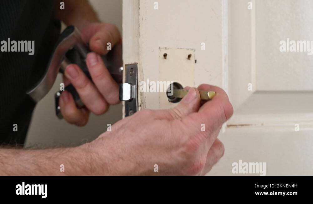 Hands insert a new spindle into a door lock barrel Stock Video Footage ...