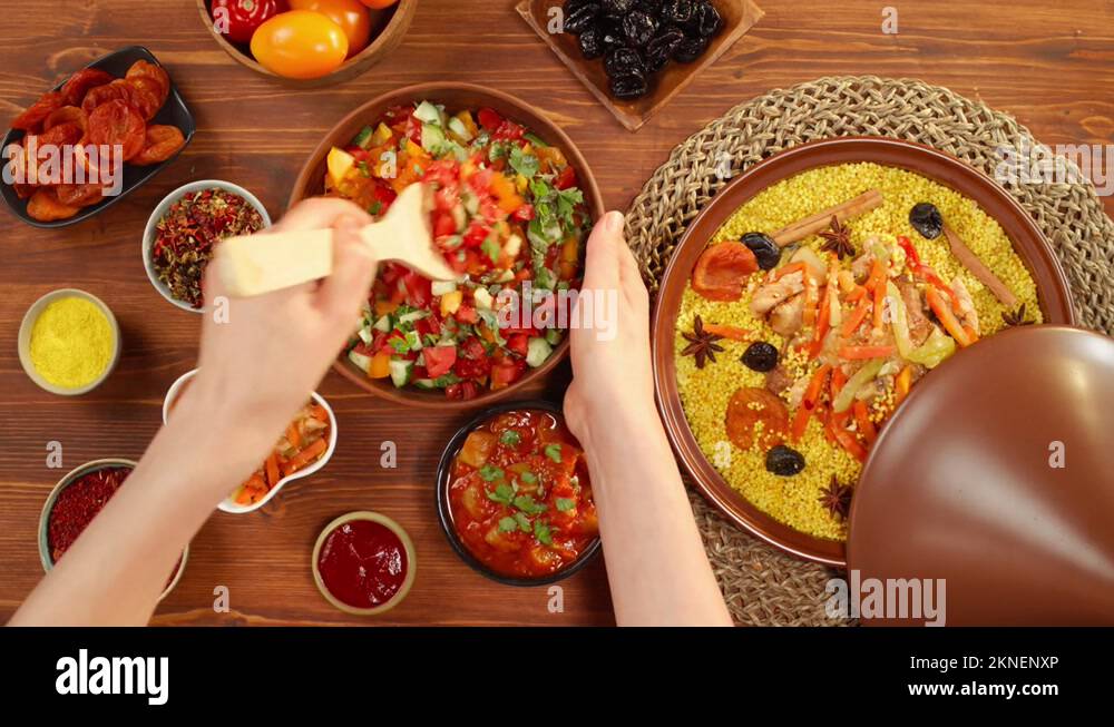 Moroccan cuisine top view. Tajine, traditional dish made of lamb and ...