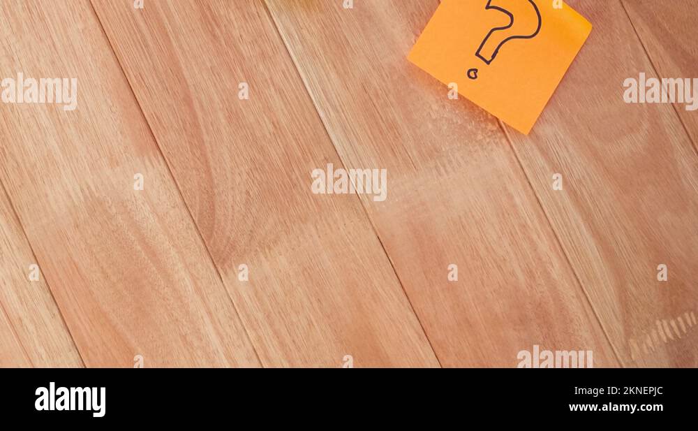 Question mark signs drawn on coloured memo notes stuck on wooden boards ...