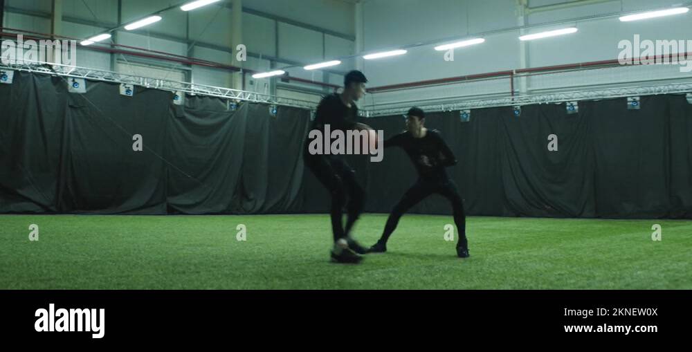 Two pro players in motion capture suits playing basketball as game ...