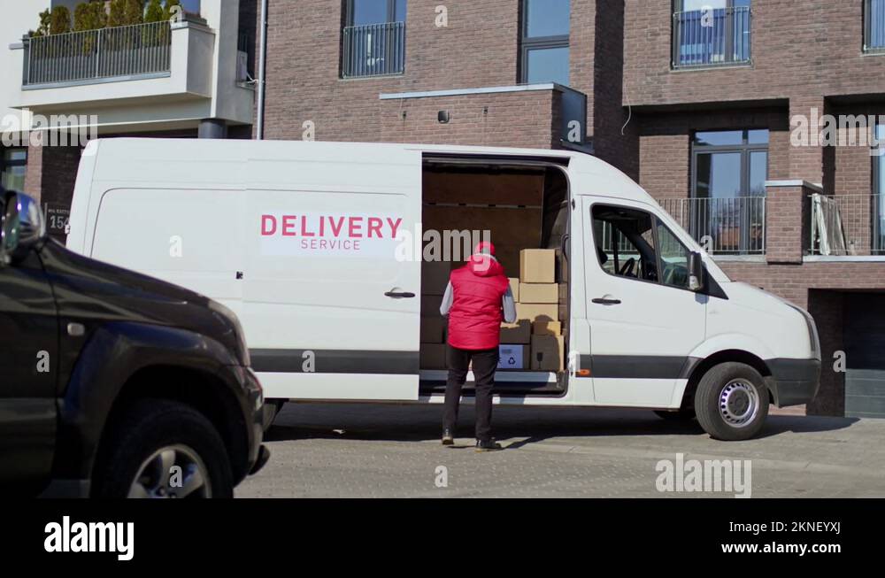 African american delivery man delivering parcel box to recipient ...