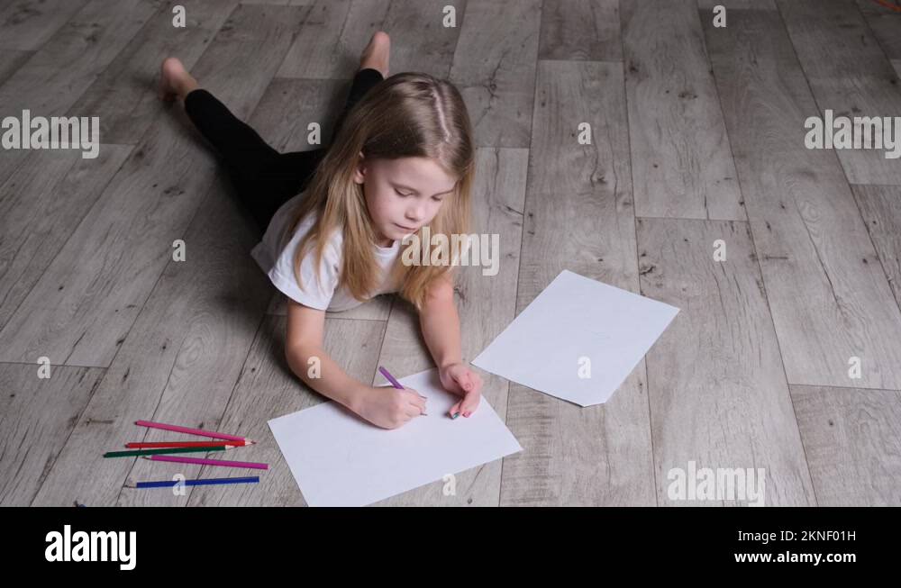 Pretty caucasian artist girl alone draws drawing with colored pencils ...