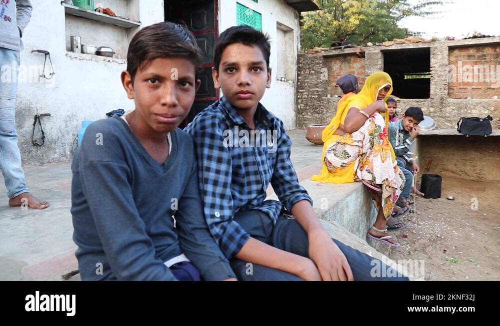 Two Indian Dalit kids from rural village of Rajasthan in India look in ...