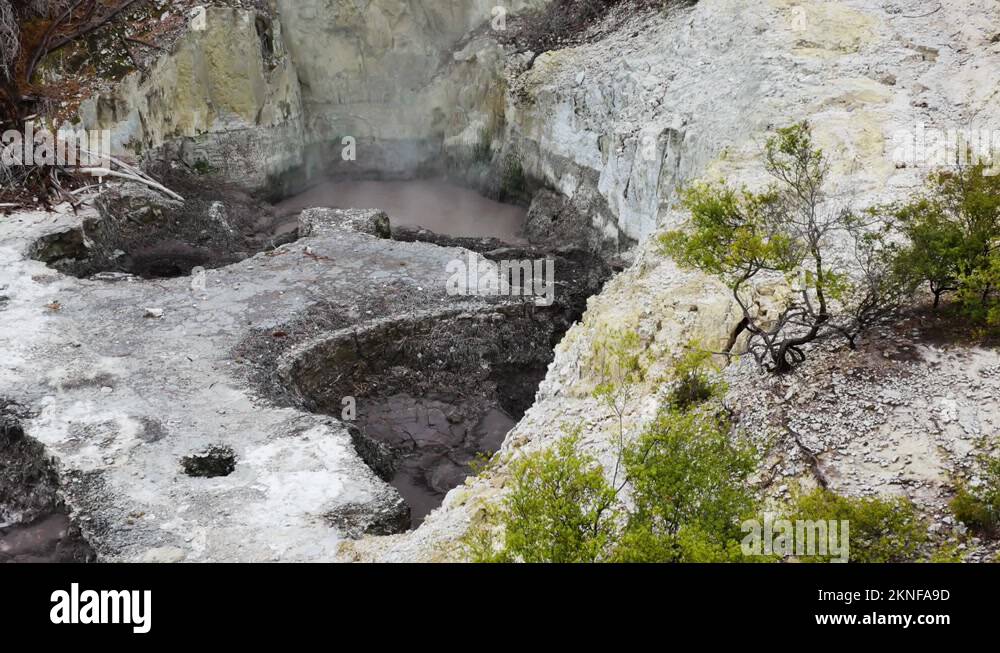 Pan shot of boiling crater in hydrothermal area of Wai-o-tapu during ...