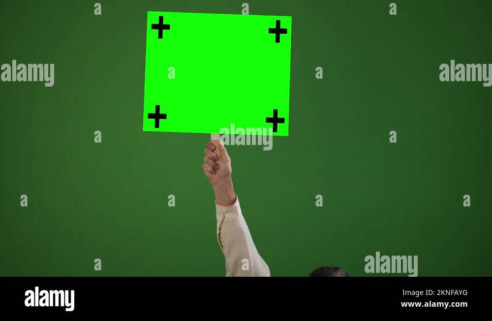 Arm holding a green screen sign with tracking points on a chroma key ...