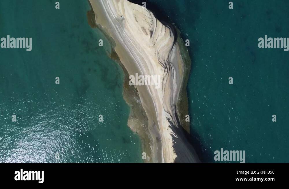 A close view of a small island made by clay in the middle of the sea in ...