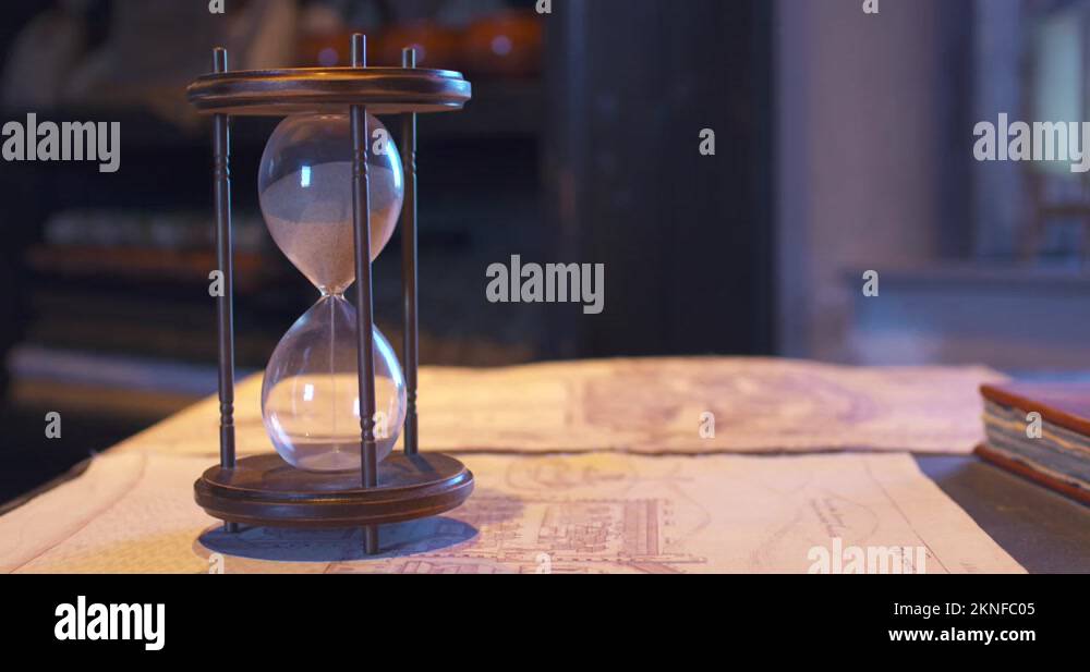 Grains of sand falling down through hourglass timer passing time Stock ...