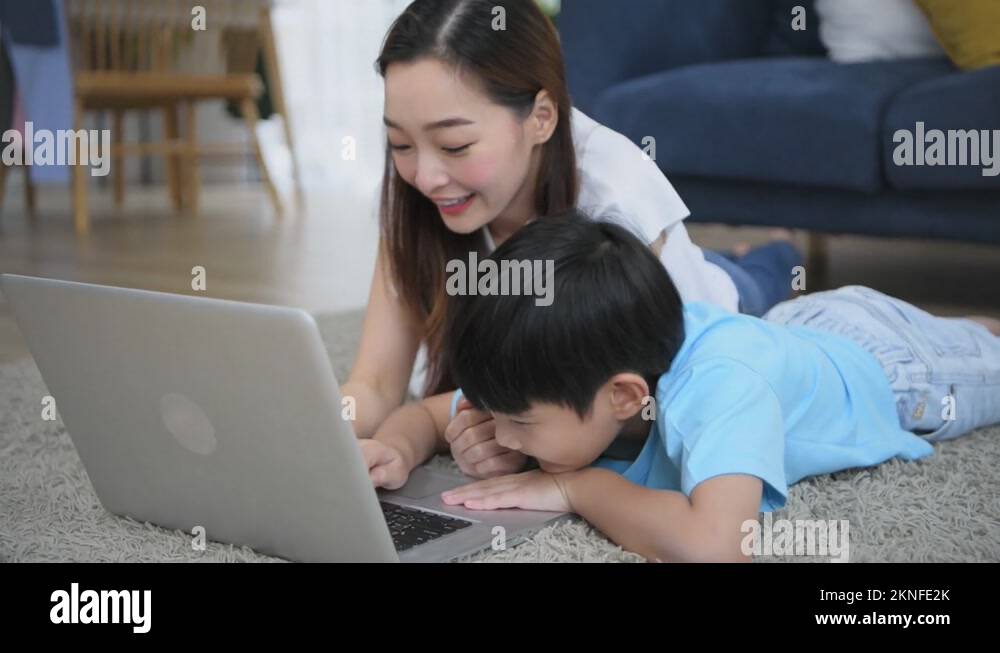 Family concept of 4k Resolution. mother teaching son to use computer at ...