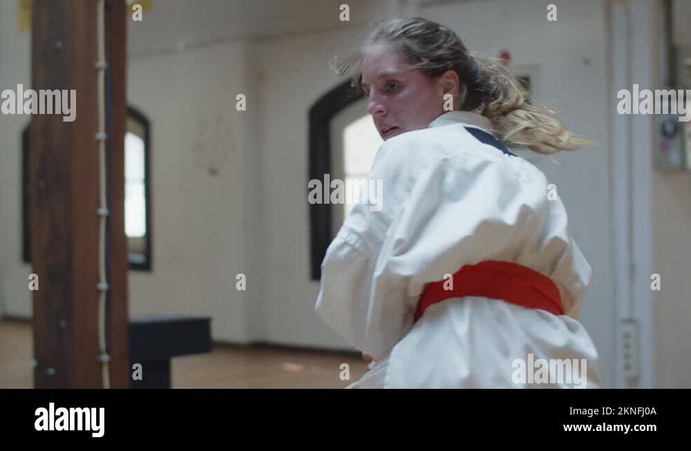 Handheld shot of focused karateka doing jump kicks at camera Stock ...