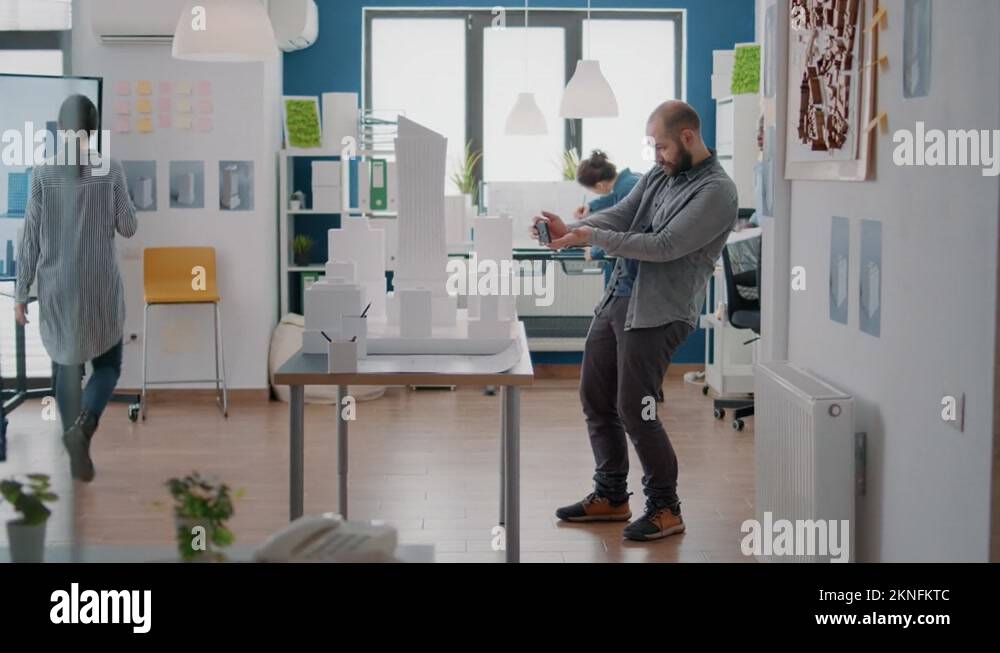 Architect Using Mobile Phone To Create Blueprints Plan With Building Model And Stock Video