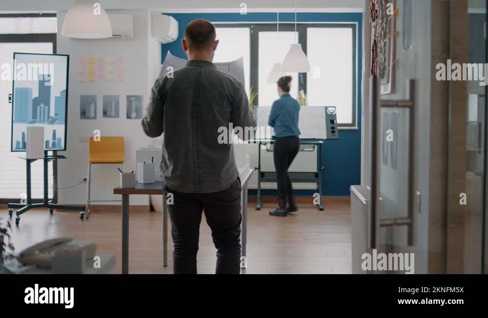 Man Architect Placing Blueprints Plan On Table To Design Building Model And Stock Video Footage