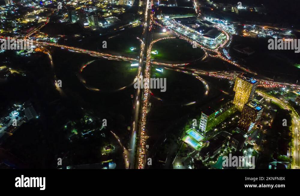 Aerial time-lapse view of traffic at night in Accra, Ghana drone slide ...