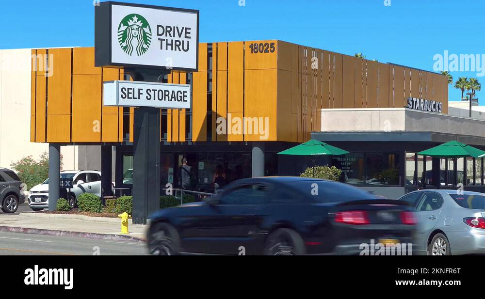Cars passing Drive Thru Starbucks coffee sign and logo in Los Angeles ...