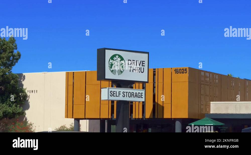 Cars passing Drive Thru Starbucks coffee sign and logo in Los Angeles ...
