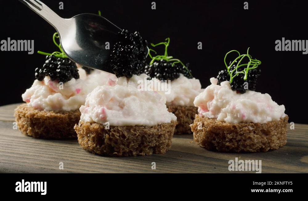 Black caviar sandwiches close-up. Bread with salted beluga sturgeon roe ...