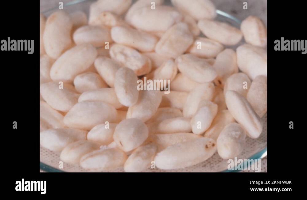 1960s: Written text on paper. Puffed rice in dish. Probe picking up ...