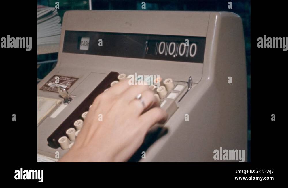 1960s: Store register. Woman's hand taps numbers and equals $1.50 ...