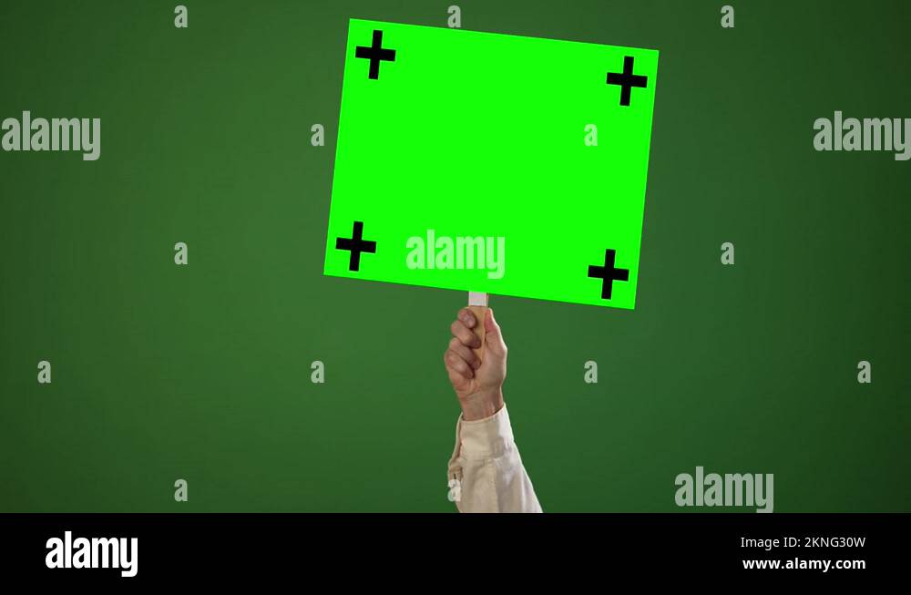 Arm holding a green screen sign with tracking points on a chroma key ...