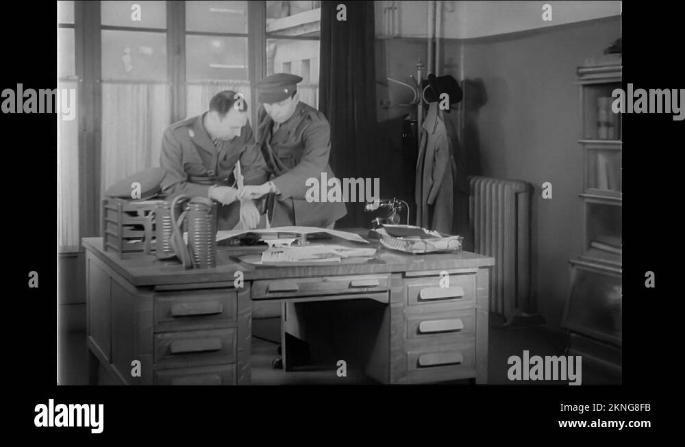 1940s: Officer in uniform at desk, officer enters, folds map, officers ...