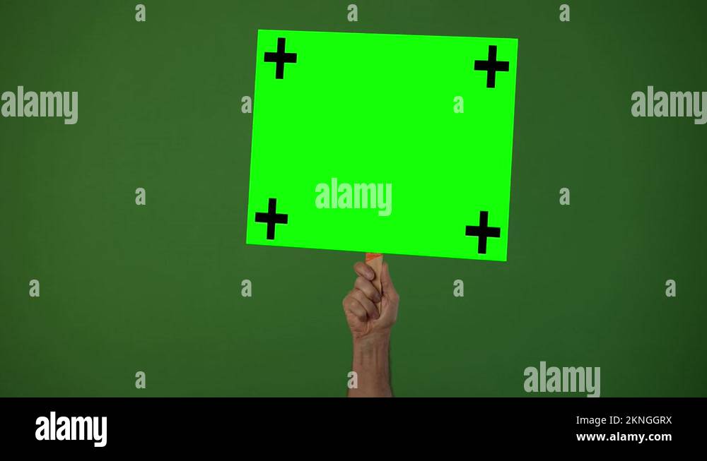Arm holding a green screen sign with tracking points on a chroma key ...