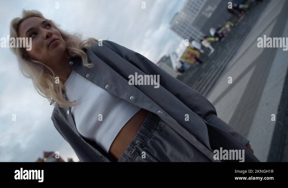 Female model street posing in city downtown with modern architecture ...