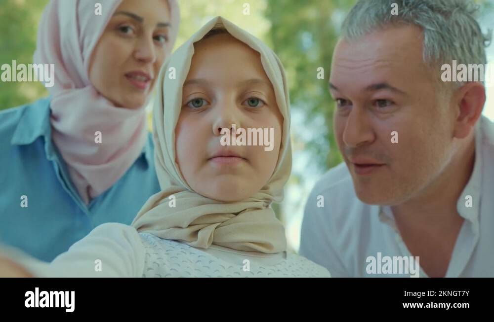 A Muslim family makes selfies and video calls using their smartphones ...