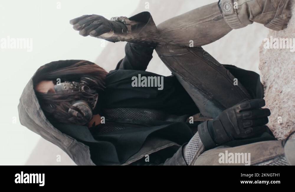 Vertical post apocalyptic female wanderer hand pouring sand sitting in ...