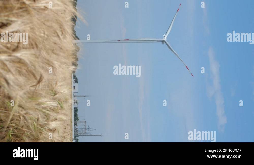 Windmill operates near substation and power lines in field Stock Video ...