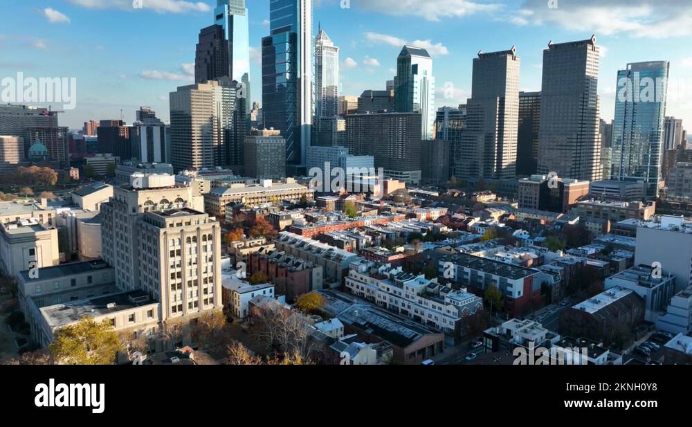 Slow tilt up reveals skyscraper highrise towers in skyline, blue sky on ...