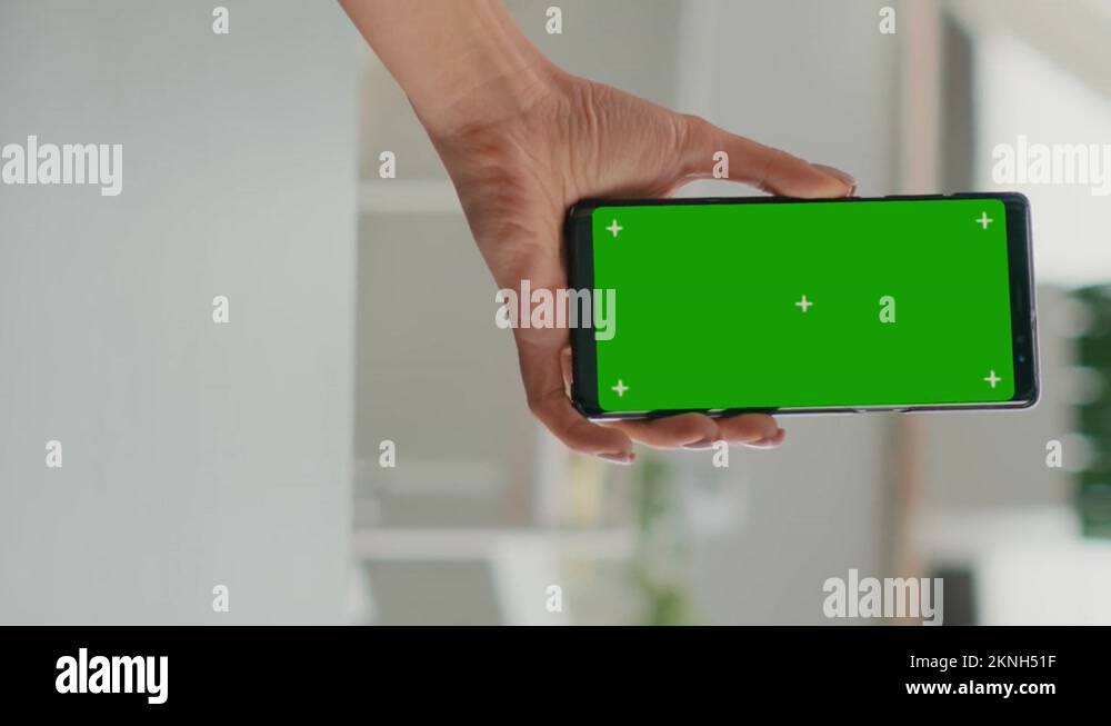 Vertical video: Business woman browsing on internet using mock up green ...