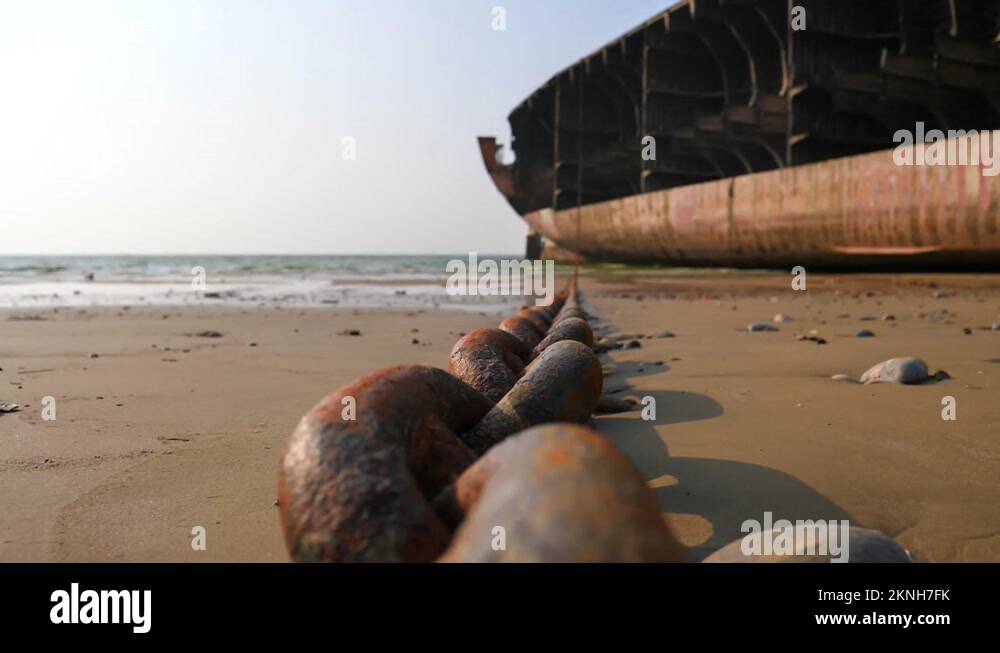 Rusty Anchor Chain Laid Out On Beach Connected To Dismantled Ship. Rack ...