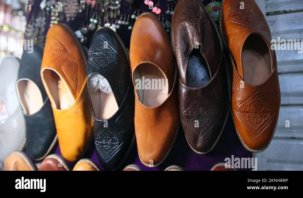 Traditional arabic leather footwear hanging in a street store in souks ...