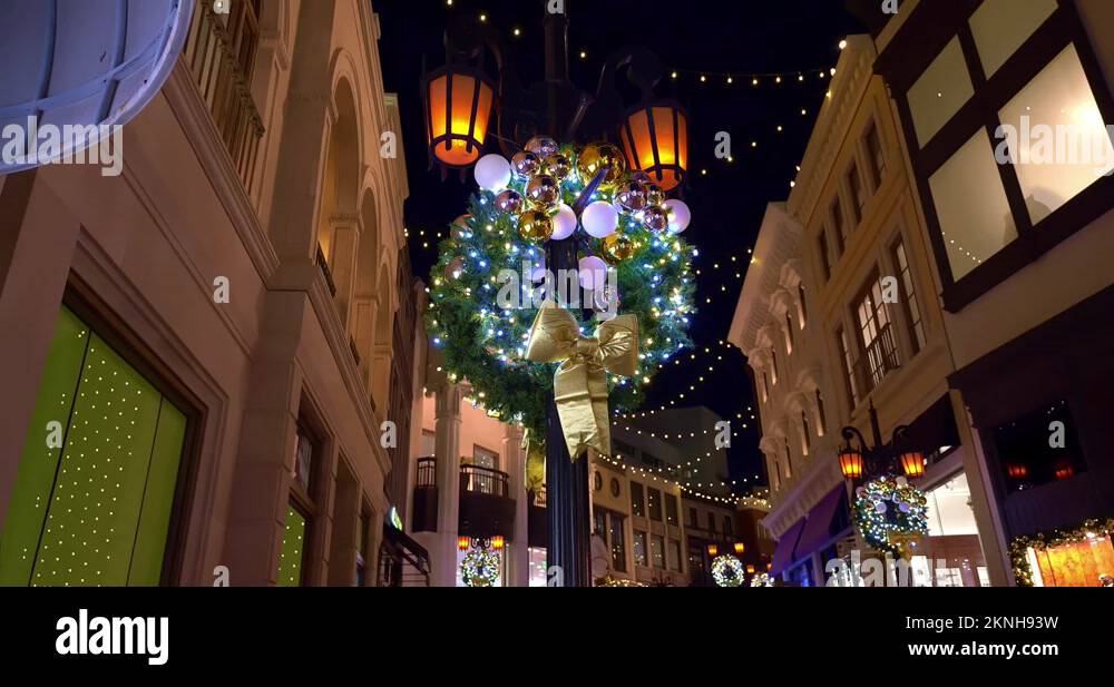 Flashing Christmas street light pole with ribbon at night in Beverly ...