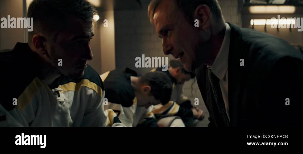 Angry disappointed coach yelling on players of hockey team in the ...