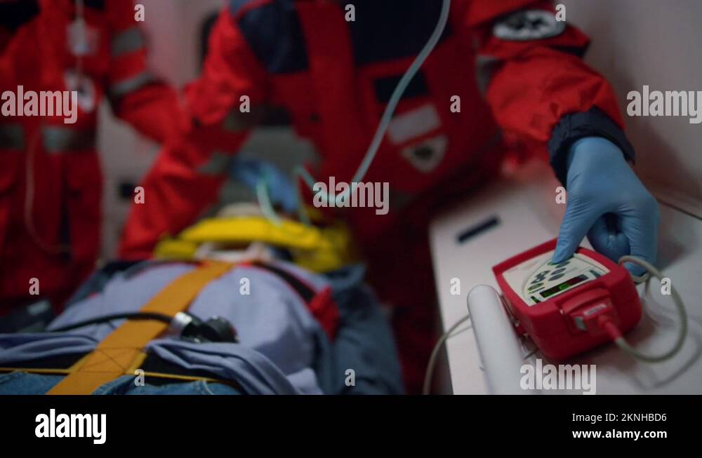 Paramedics hands in gloves providing emergency care of patient in ...