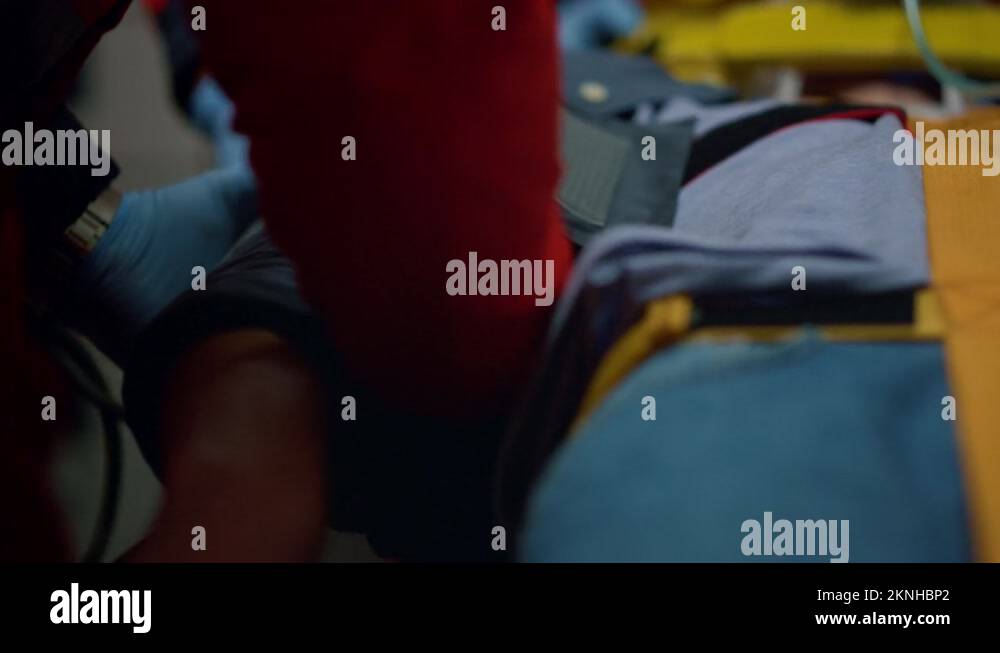 Medical workers hands measuring blood pressure of man with mechanic ...