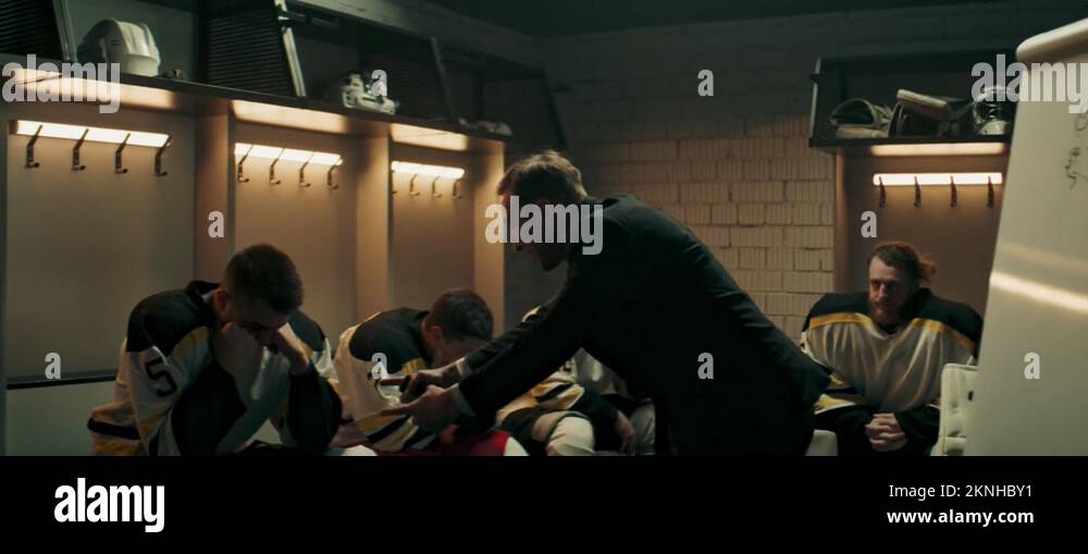 Angry disappointed coach yelling on players of hockey team in the ...