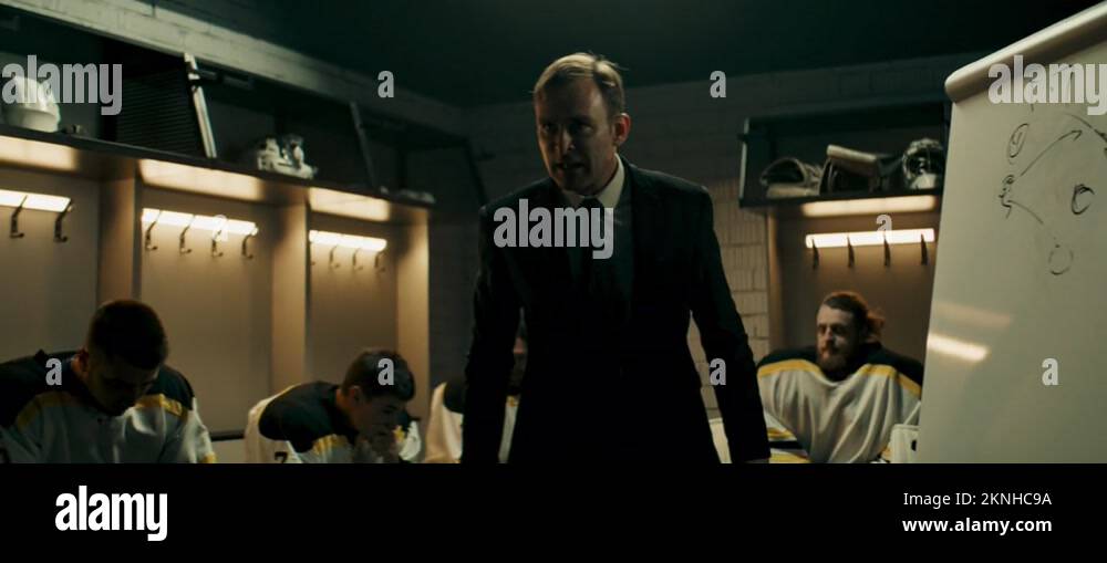 Angry disappointed coach yelling on players of hockey team in the ...