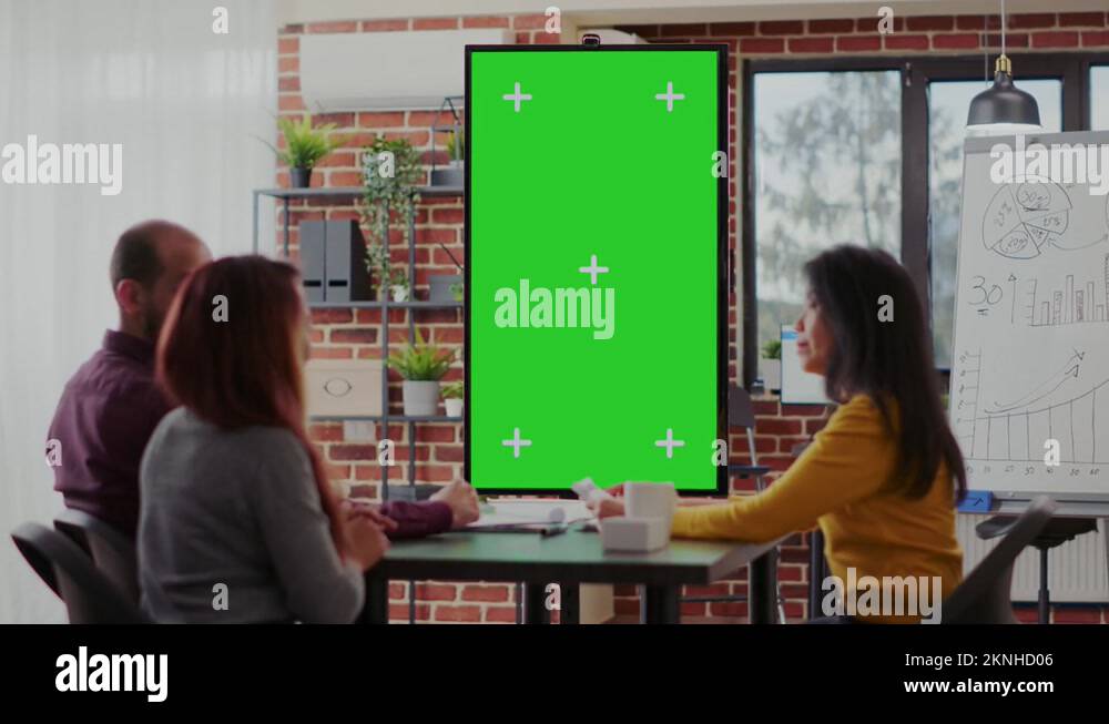 Employees using green screen on monitor vertically in boardroom Stock ...